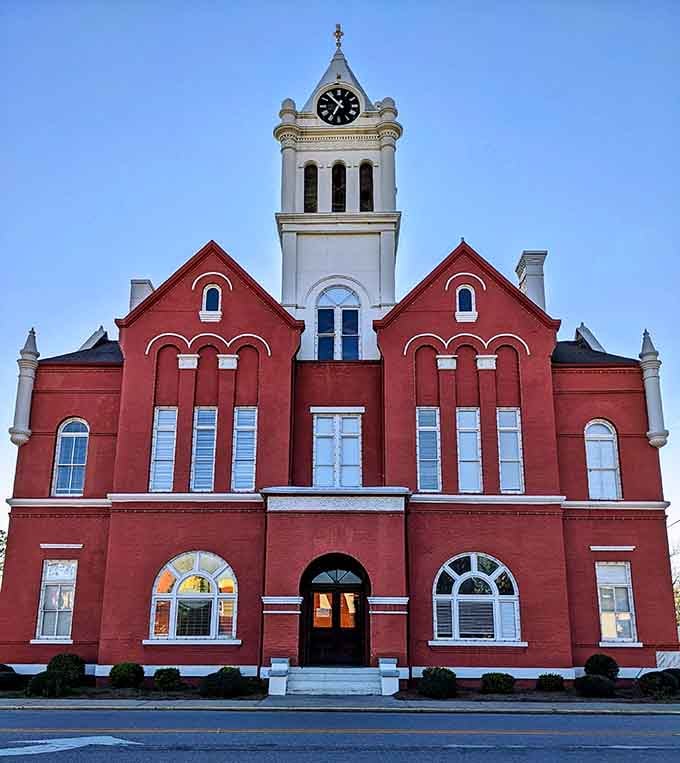 The Schley County Courthouse stands magnificent in red brick, proving government buildings once had actual personality.