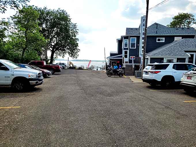 Parking lot view that hints at the lakeside treasure waiting just beyond those cars and trees ahead.