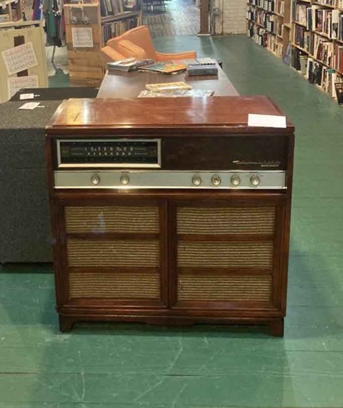This vintage console record player is pure mid-century elegance, combining furniture and music in one beautiful wooden package.