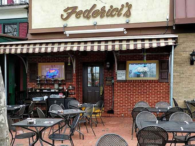 Outdoor seating with striped awning overhead, because sometimes the best way to enjoy great pizza is under the open New Jersey sky.