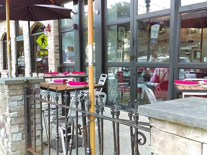 Outdoor seating with wrought iron details transforms sidewalk dining into something worth planning your evening around.