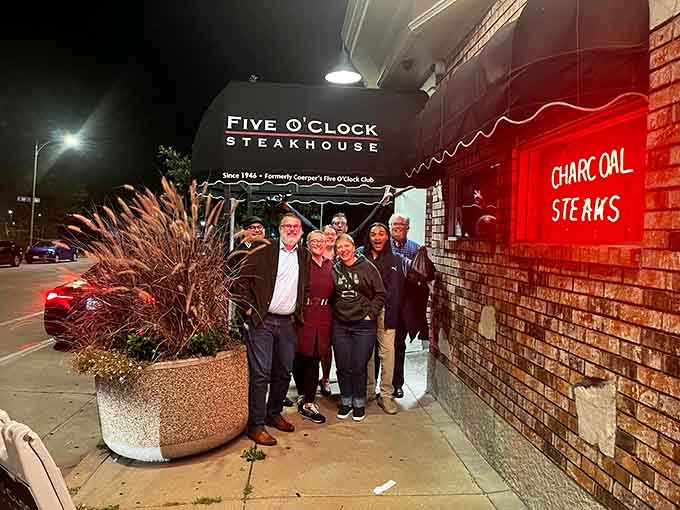 Smiling customers outside the restaurant, already planning their next visit before they've even left the first one.