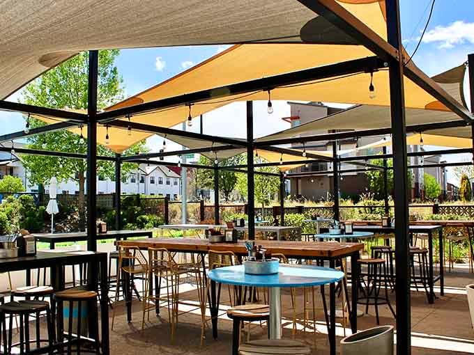 Shaded patio seating under modern canopies; outdoor dining elevated to new heights, though technically you're still on ground level.