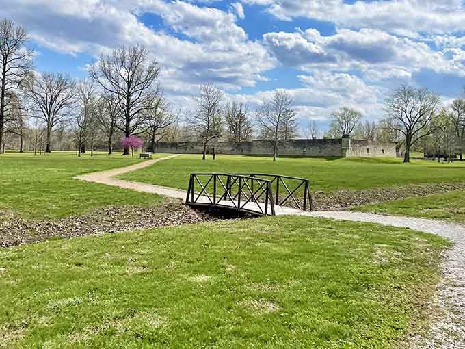 A charming wooden bridge crosses the grounds, adding a touch of storybook appeal to this very real historical site.