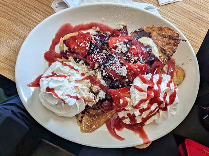 French toast loaded with berries and whipped cream transforms breakfast into dessert without anyone complaining about it.