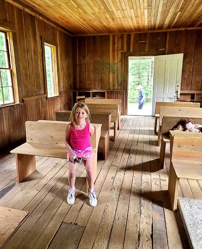 Young visitors discover that pioneer kids sat in these same desks, probably daydreaming about recess too.