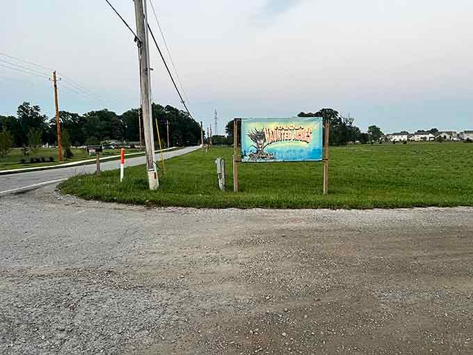 The roadside sign cheerfully announces your upcoming descent into madness, visible from the safety of your passing car.