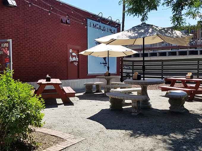 The outdoor patio offers umbrellas, sunshine, and the perfect setting for contemplating your next hot dog adventure.