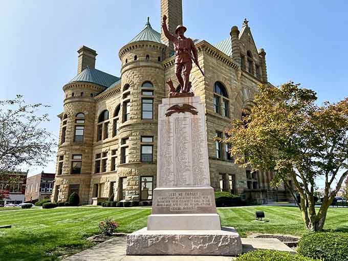 The Civil War monument standing sentinel before the courthouse, honoring sacrifice while that gorgeous stonework showcases craftsmanship we've nearly lost.
