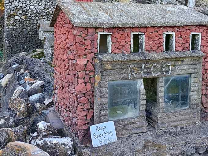 The Reco Sporting Goods building replica sits perfectly detailed with its pink stone facade, immortalizing local history in pebbled perfection.