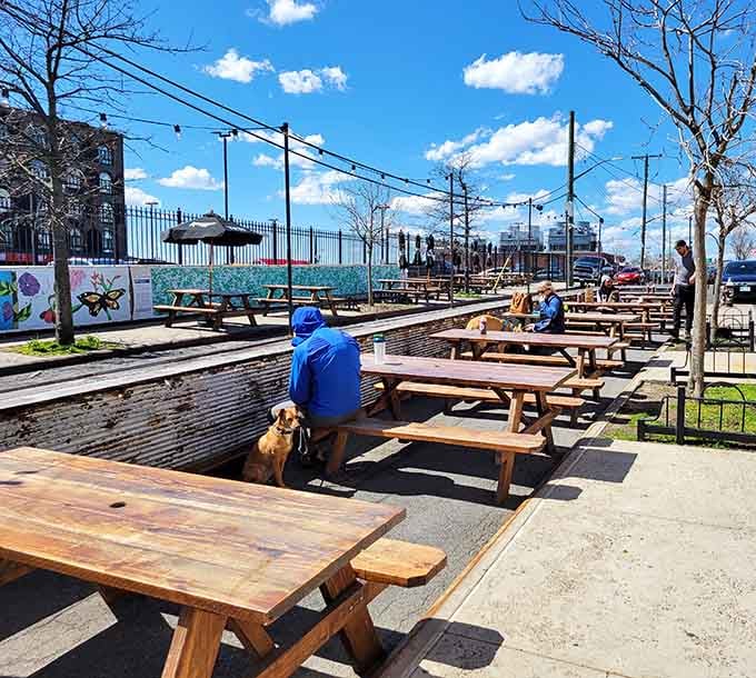 Sunny outdoor seating with picnic tables offers waterfront views where you can enjoy your feast alfresco style.