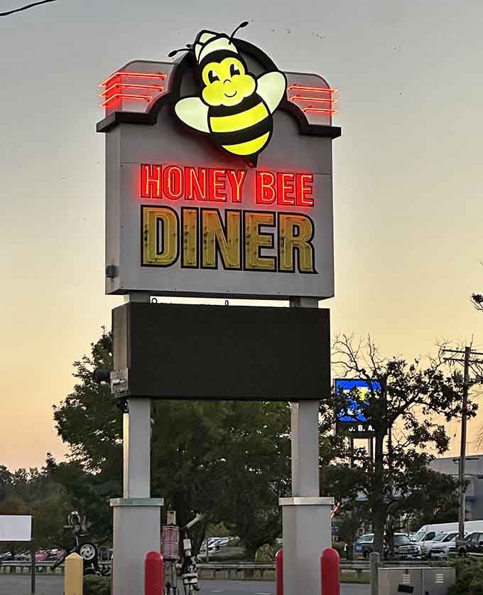 The roadside sign stands tall like a friendly giant, promising good food and delivering on every single word.