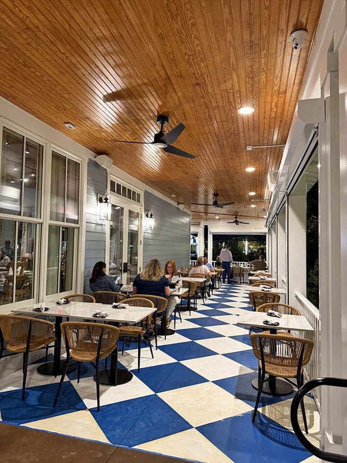 Outdoor seating with blue and white checkered floors offers fresh air and Southern charm in equal, generous measures.