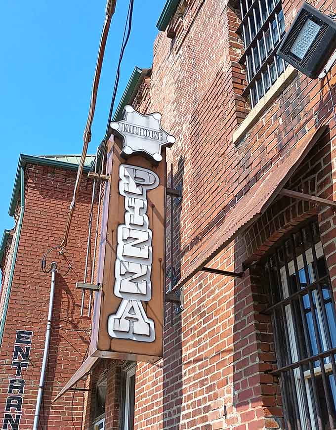 That vertical "PIZZA" sign hanging on historic brick tells you everything you need to know about Brandenburg's priorities: excellent.