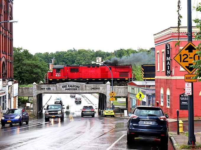 That red railroad bridge spanning the street is pure industrial poetry and an Instagram moment waiting to happen naturally.