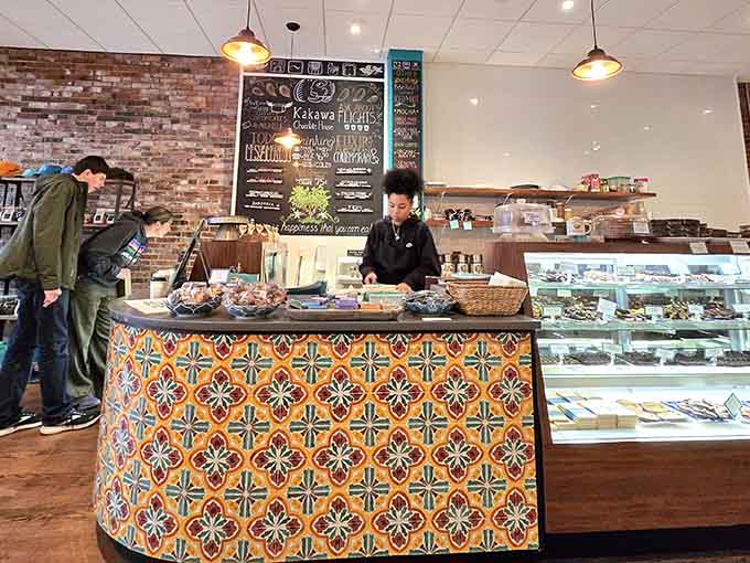 The colorful tiled counter and display case create a vibrant focal point where chocolate dreams become delicious reality.