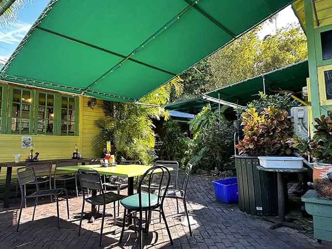 Shaded patio seating surrounded by tropical plants, the perfect spot for pie-induced contemplation and happiness.