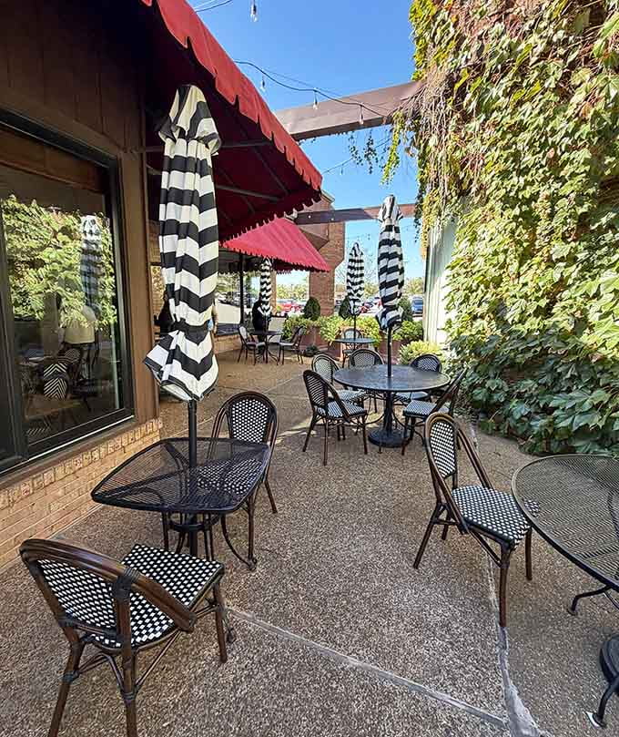 Black and white striped umbrellas shade the patio, creating a charming outdoor space for warm-weather pastry enjoyment.