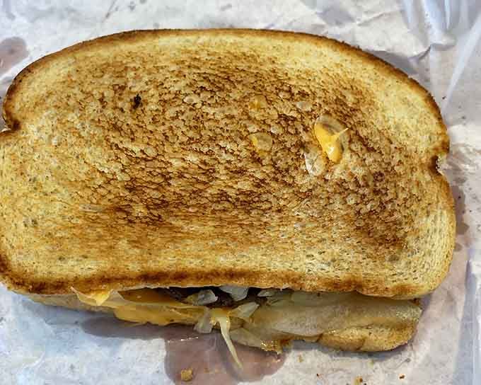 A grilled sandwich that's been toasted to golden perfection, because even simple things deserve proper attention here.