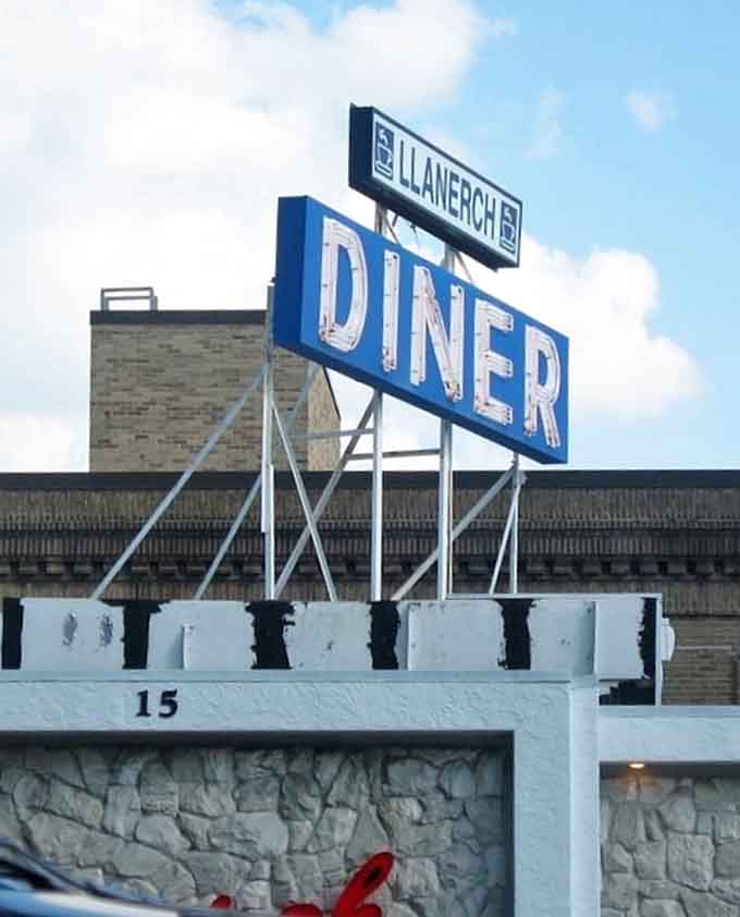 The Llanerch sign standing tall, promising good food and better memories for everyone who pulls in.