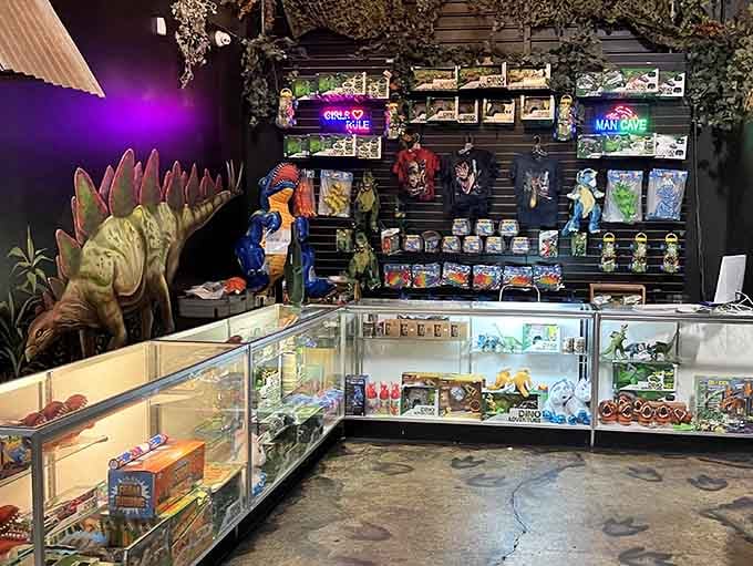 The souvenir shop displays treasures beneath a stegosaurus, tempting visitors with mementos of their prehistoric adventure today.
