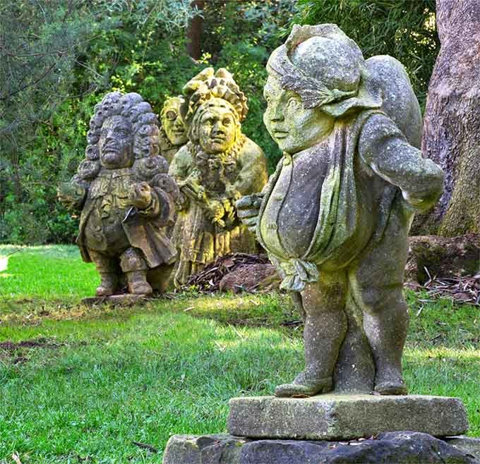 These weathered garden statues add character and whimsy, like they've been keeping watch over these grounds for generations of visitors.