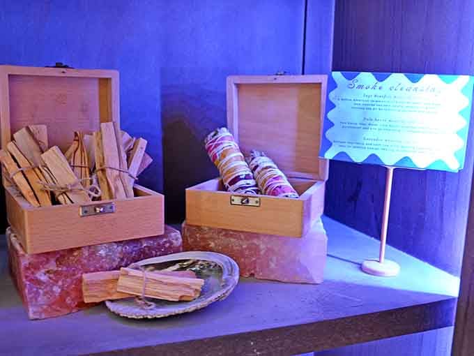 Smudge sticks and cleansing tools displayed in wooden boxes, because spiritual wellness comes in many forms here.
