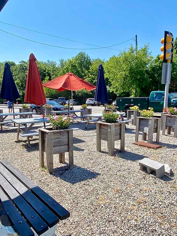 Outdoor patio seating with umbrellas and planters &ndash; proof that breakfast tastes better when you're soaking up some sunshine.