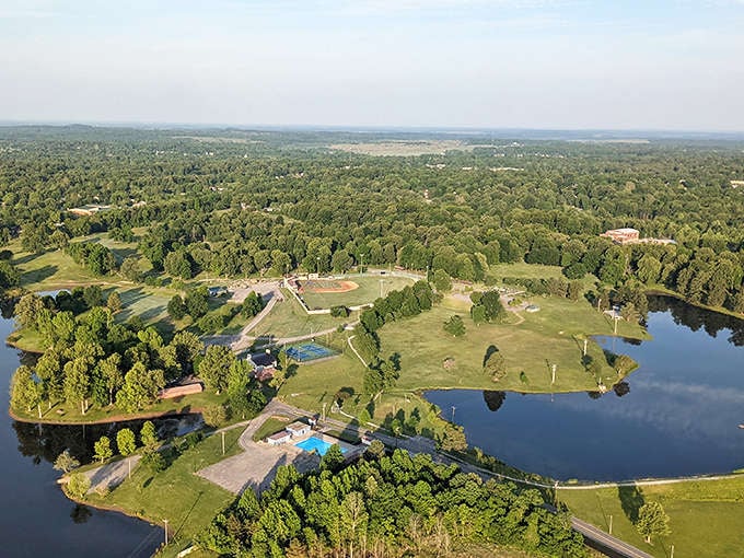 Aerial views reveal the natural beauty surrounding Madisonville, where lakes and green spaces actually outnumber parking lots.