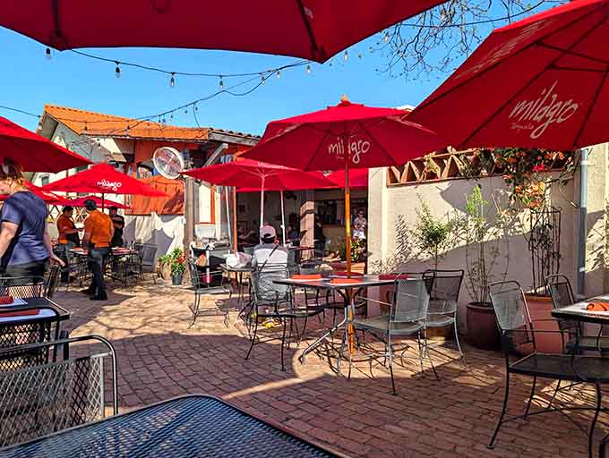 Red umbrellas and patio seating where you can enjoy your enchiladas under the Texas sky, margarita in hand.