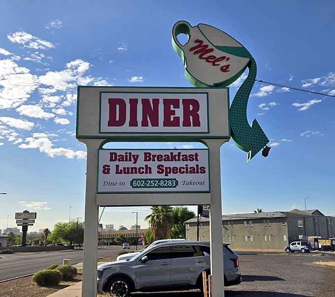 The sign stands tall like a delicious lighthouse guiding hungry travelers to their breakfast salvation.