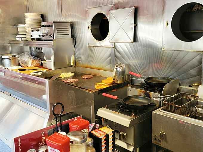 Behind the scenes, this tiny kitchen produces miracles through organized chaos and decades of practiced precision.