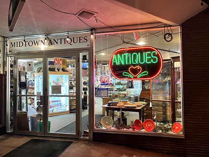 That glowing neon heart in the window promises love at first sight for antique enthusiasts passing by.