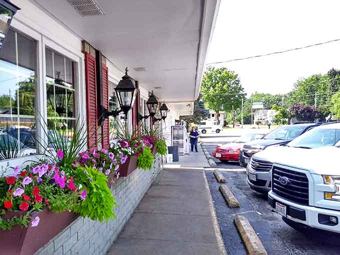 Flower boxes and classic lanterns dress up the exterior, proving that curb appeal matters even when your food speaks for itself.