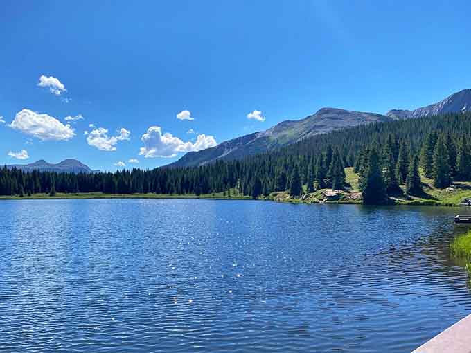 Alpine lakes reflect perfect skies, offering moments of zen between the highway's more adrenaline-inducing stretches of asphalt.