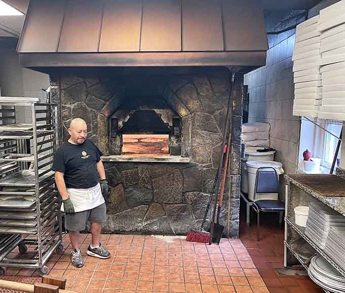 Standing before that massive coal-fired brick oven is like witnessing pizza magic in its natural habitat.