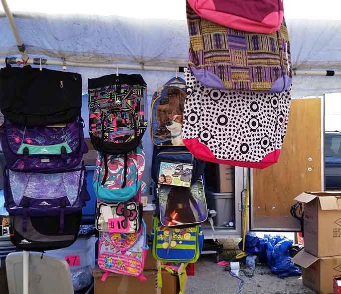 Backpacks and bags hang ready for adventure, proving practical items can be both functional and budget-friendly at Montana Charlie's.