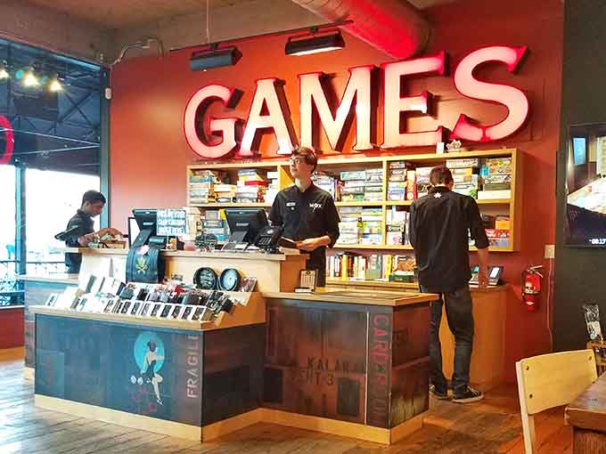 The friendly staff behind the games counter, ready to recommend your next obsession and explain rules without judgment.