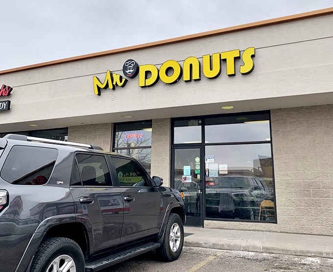 Strip mall exterior hiding breakfast gold inside, never judge a donut shop by its parking lot, always by its glaze.