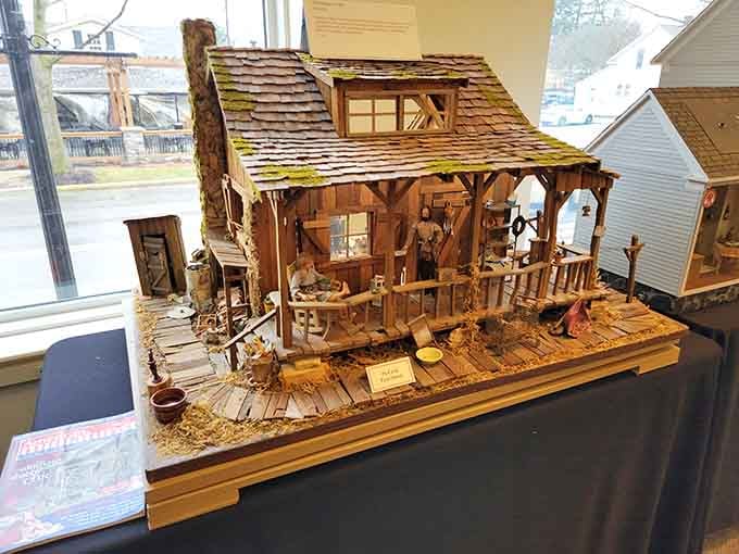 A rustic cabin showcasing weathered wood and frontier charm, proving miniaturists can capture any architectural style beautifully.