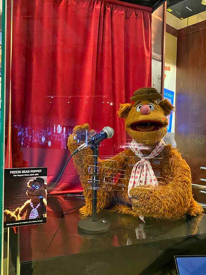 Fozzie Bear stands ready with microphone in hand, forever frozen in that moment before delivering another wonderfully terrible pun.