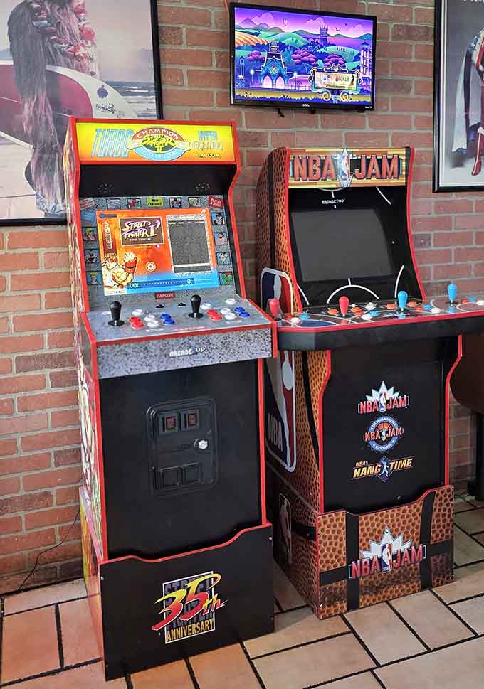 Classic arcade cabinets let you relive your youth between bites, because nostalgia tastes even better with burgers.