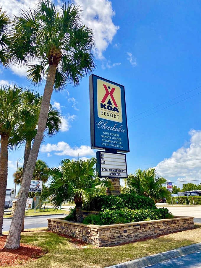 The welcoming sign lists amenities that sound more like a luxury resort than a traditional campground experience.