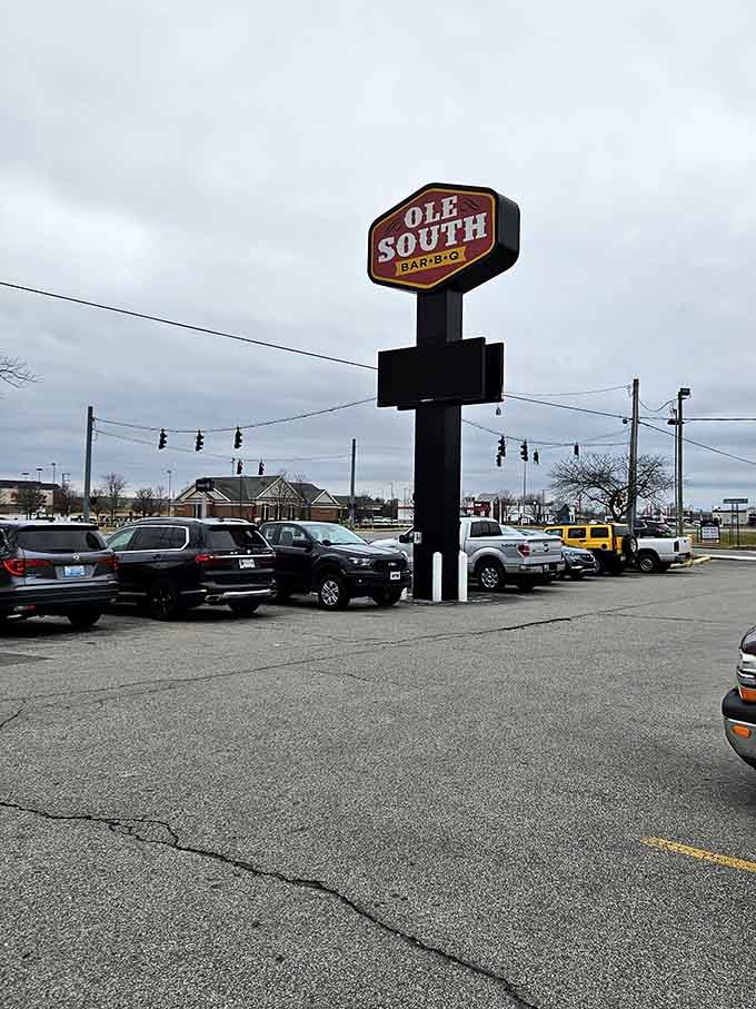 That sign is your beacon of hope on the highway, guiding hungry travelers to smoked meat salvation.