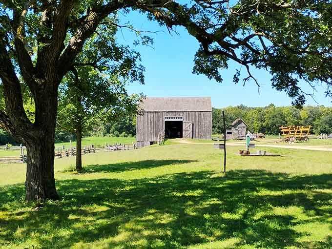 Weathered barn and vintage wagon under shade trees create postcard-perfect scenes that transport you straight to 1860s.