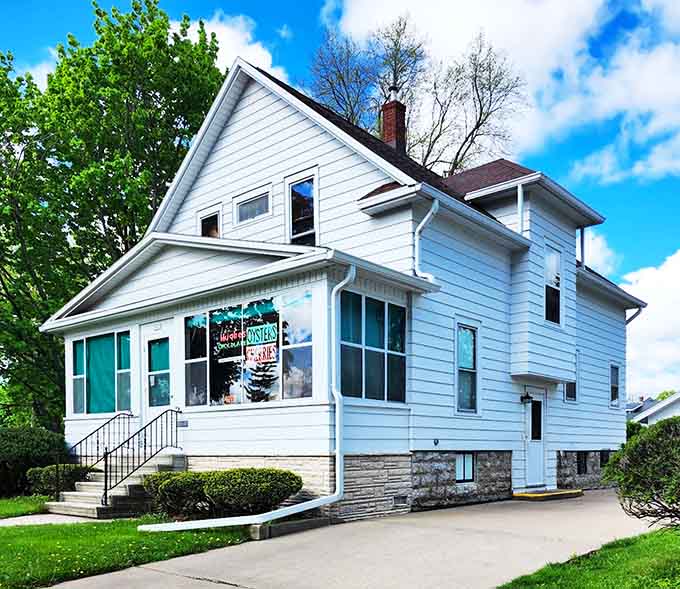 Hughes' Home Maid Chocolates Shop occupies a charming house where sweet treats emerge like edible proof that happiness exists.