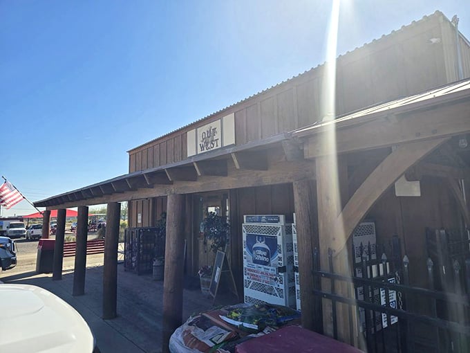 Sunlight streams through the porch overhang, illuminating the entrance to this beloved roadside treasure that defies all GPS logic.