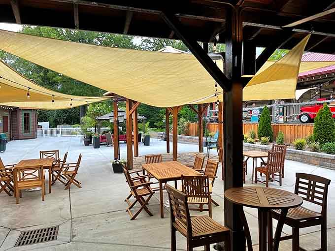 Outdoor seating under shade sails, perfect for when you need fresh air to recover from your pork chop victory.