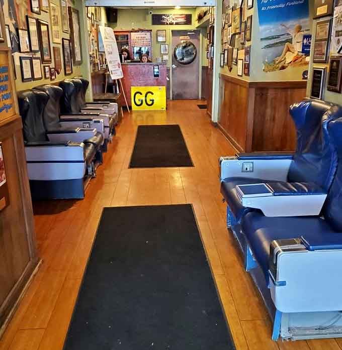 The waiting area styled like an airplane cabin sets the aviation theme before you even reach your table.