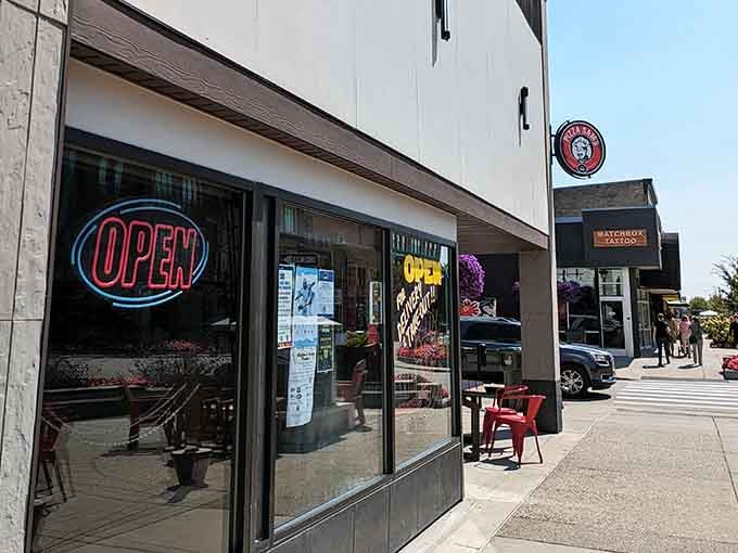 The neon glow that's guided hungry locals to pizza paradise for longer than most chain restaurants have existed.